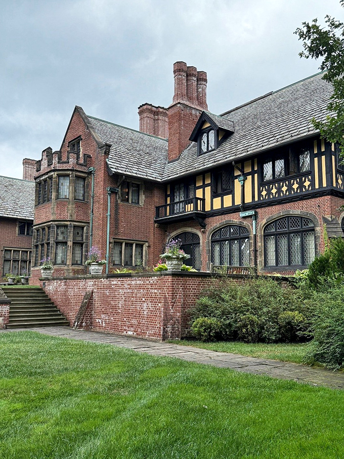 Tudor-style half-timbering and multiple chimneys create a fa&ccedil;ade that practically demands to be photographed from every possible angle.
