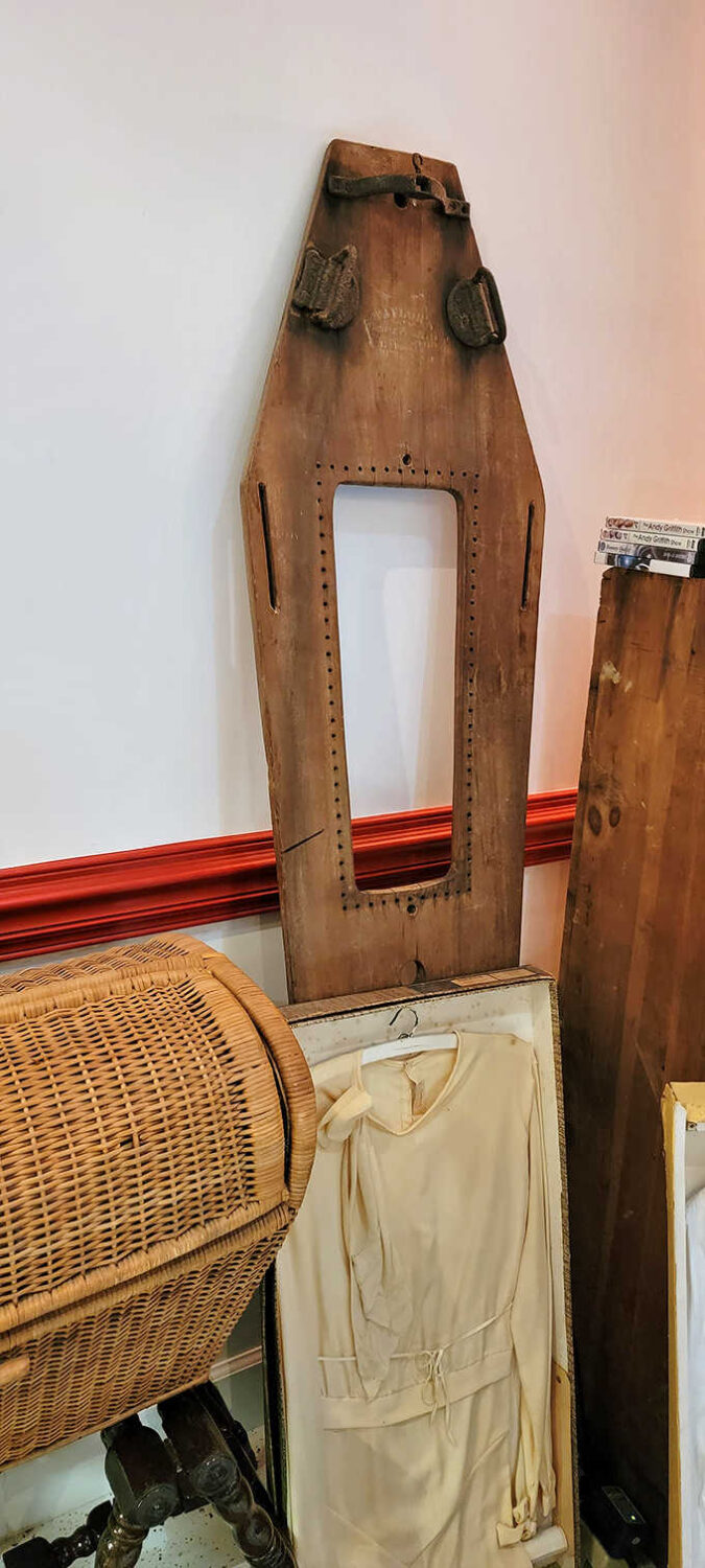 This wooden cooling board with straps was an essential tool before modern refrigeration &ndash; practical necessity meeting somber purpose.