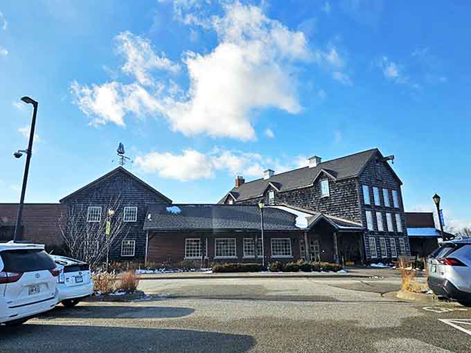 At the parking area: The museum's distinctive silhouette stands against a perfect blue sky, promising artistic treasures within its weathered nautical exterior.