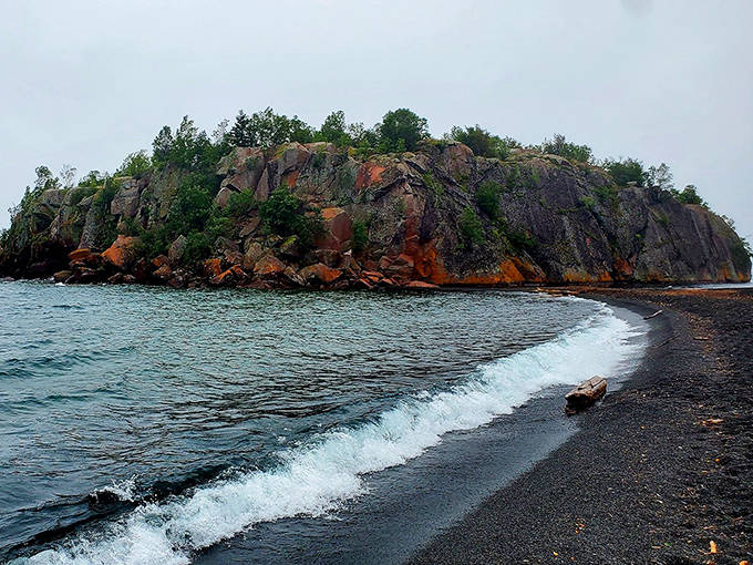 The dramatic meeting of black volcanic sand and clear Superior waters creates a shoreline that belongs in a geology textbook.