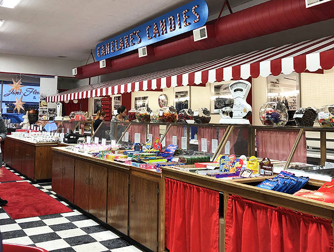 Candy counter paradise! Red and white striped awnings hover over display cases filled with handcrafted confections waiting to be discovered.