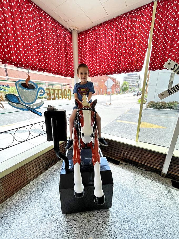 The mechanical horse ride &ndash; where today's children bounce on the same steed their parents rode decades ago, creating perfect generational symmetry.