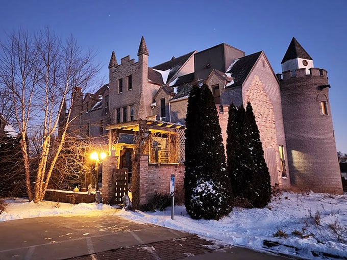 As night falls, the illuminated castle transforms into a magical beacon, its windows glowing with warmth against the darkness of rural Illinois.