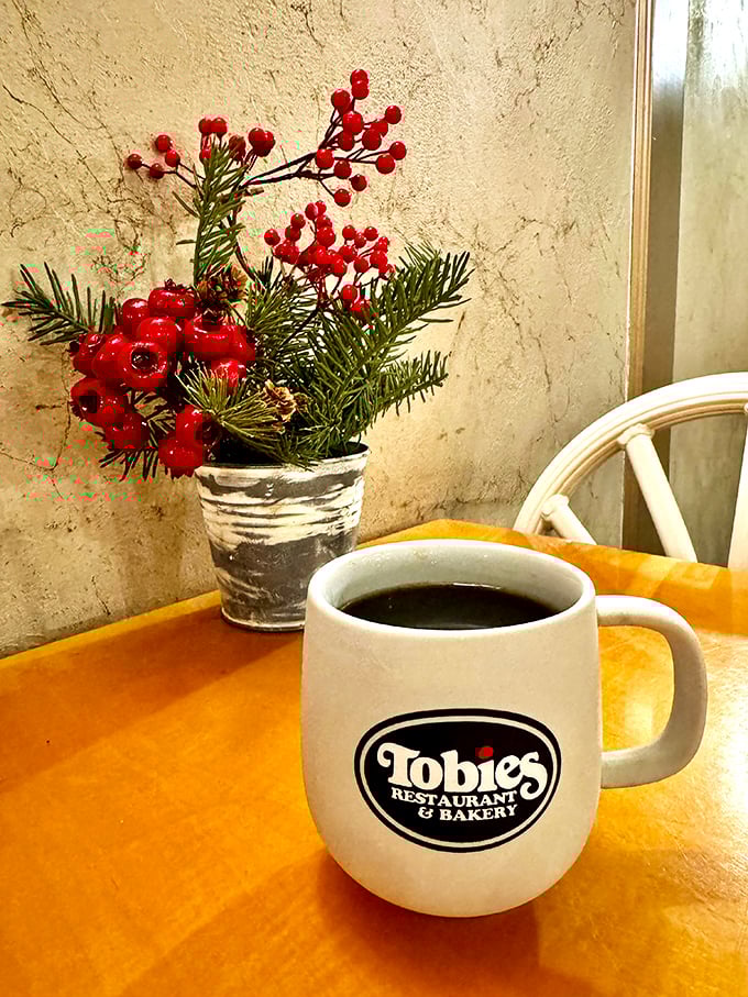 A steaming mug of coffee next to seasonal decor &ndash; Tobie's knows the importance of creating moments of comfort for weary travelers.