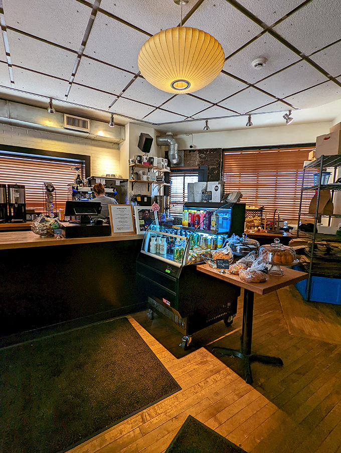 The caf&eacute;'s interior balances cozy and sophisticated, with warm wood tones and natural light creating an atmosphere that invites lingering.