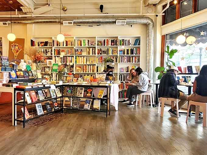 Bright, airy spaces with rainbow-organized shelves invite lingering, where every corner feels designed for both concentration and conversation.