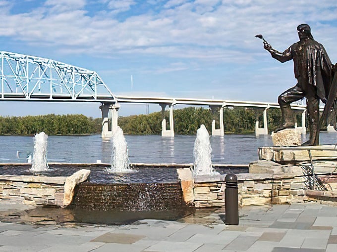 La Crosse's riverside statue celebrates the enduring relationship between river and community, with water stretching to the horizon.