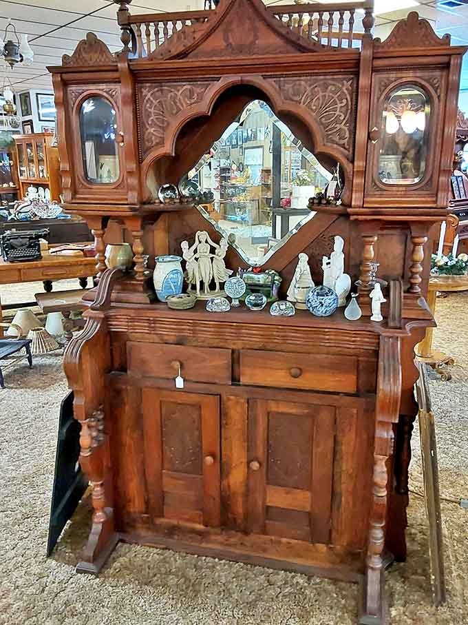This ornate Victorian sideboard with beveled mirror represents an era when furniture wasn't just purchased but invested in for generations.