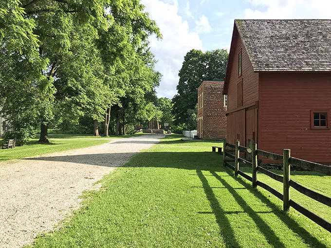 This gravel path leads between historic buildings, inviting visitors to stroll at a 19th-century pace without 21st-century notifications interrupting.