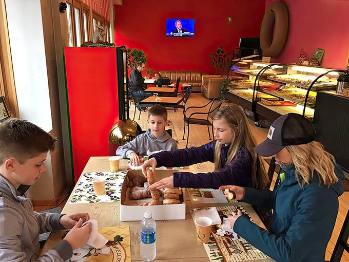 Families gather around boxes of donuts, creating memories sweeter than the glazed treats they're sharing.