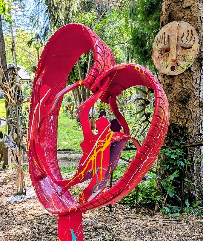 A haunting face assembled from hundreds of small metal objects stares across the garden, each component telling its own story.