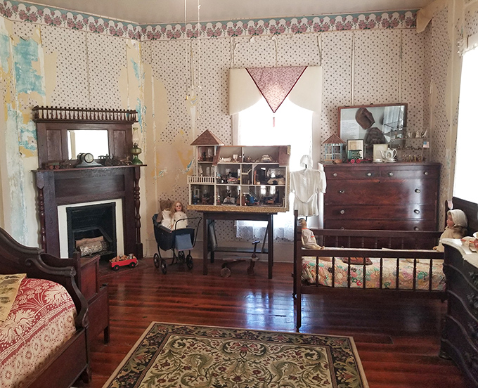 The children's bedroom, complete with antique toys and a dollhouse, poignantly captures the brief childhoods of the Victorian era.