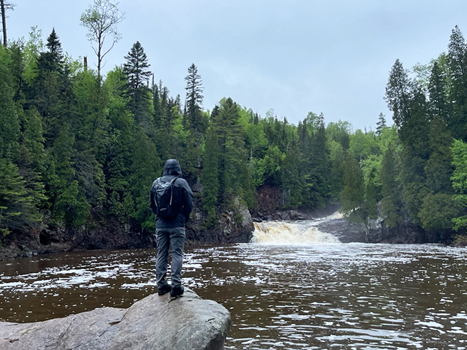 A hiker contemplates the falls from a distance&mdash;that universal moment when you realize your smartphone camera will never do justice to what you're seeing.