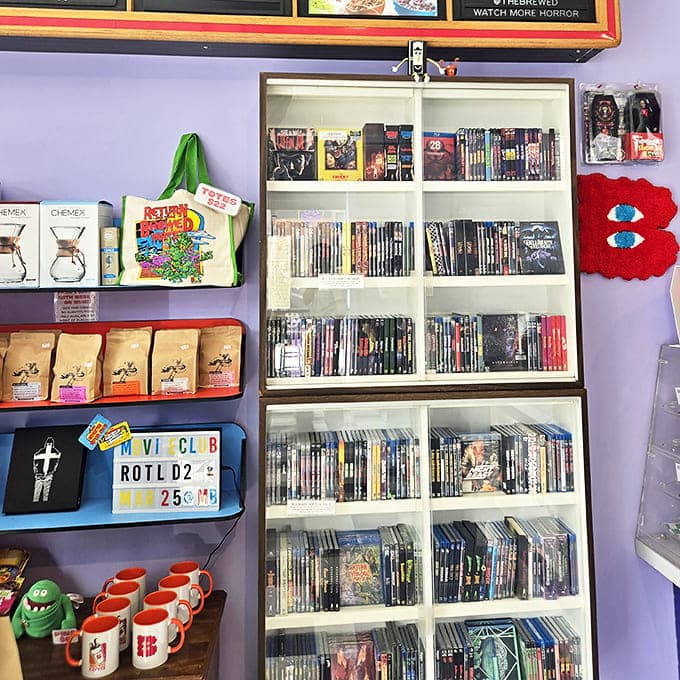 Horror DVDs line the shelves alongside coffee merchandise, creating a browsable museum of fright while you wait for your latte.