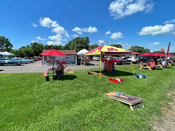 Picnic tables and umbrellas transform the grassy area into a community gathering space, where the simple pleasure of outdoor dining enhances every bite.