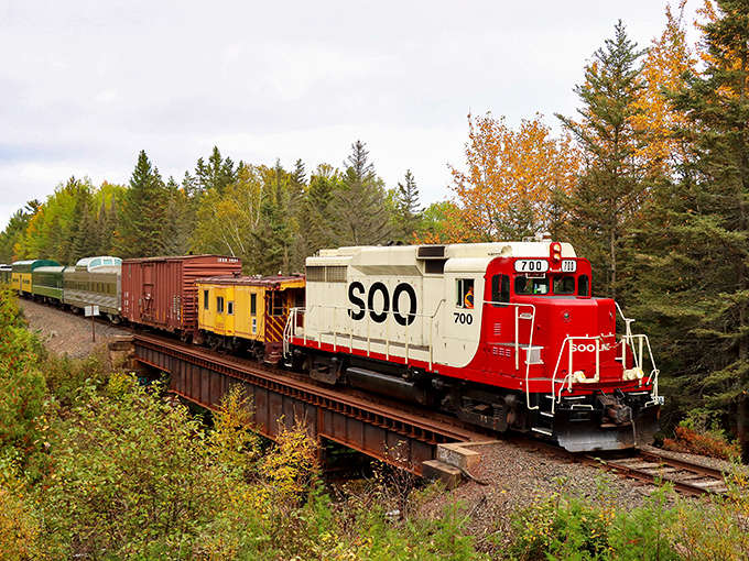 Autumn transforms the journey into a moving kaleidoscope of color, with the SOO Line's distinctive livery adding a pop of contrast.
