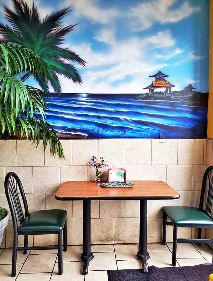 A quiet corner with ocean views (via mural) provides the perfect spot to savor authentic Jamaican flavors while escaping Michigan's reality.