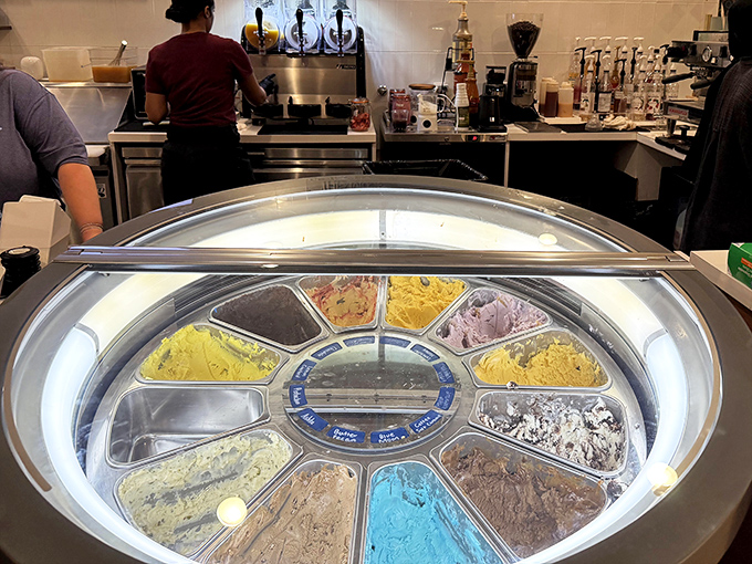 The gelato case presents a wheel of frozen possibilities, each colorful scoop promising to transport you to Italian piazzas without the airfare.