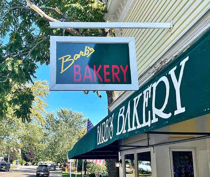 The simple "Barb's BAKERY" sign glows like a beacon for sugar-seekers, promising sweet salvation to anyone wise enough to follow its neon guidance.