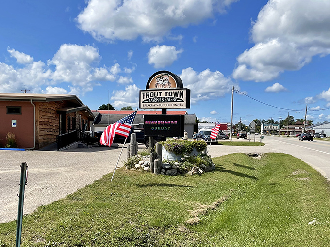 The Trout Town sign stands proud against Michigan's big sky, American flags fluttering in welcome to hungry travelers and locals alike.