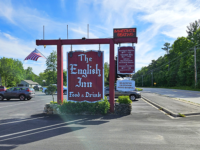 The iconic English Inn sign swings gently in the breeze, a beacon for hungry travelers and locals alike seeking a taste of old-world charm.