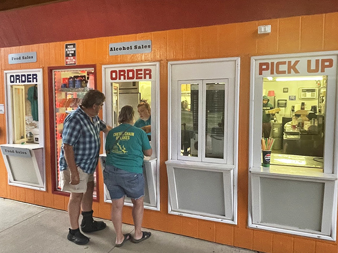 Friendly staff serve customers at the well-organized concession windows, offering both food and beverages for the show.