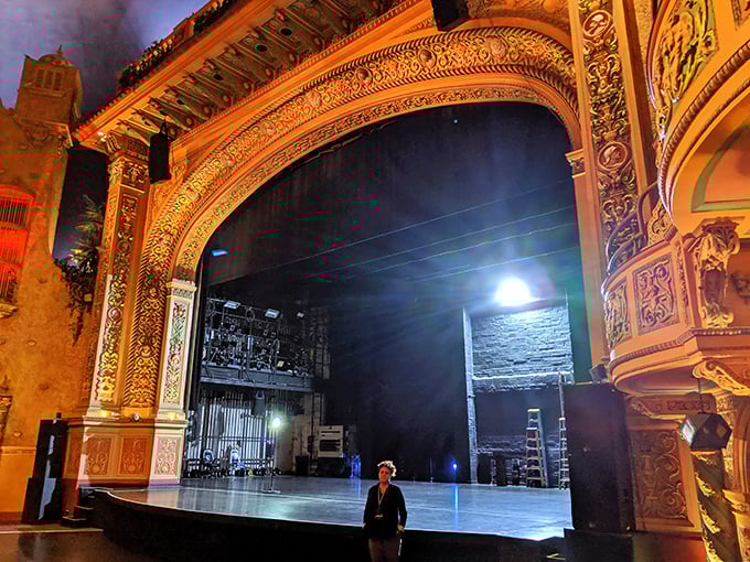 The ornate proscenium arch frames the stage like a gilded portal to another dimension, where every performance begins with architectural applause.