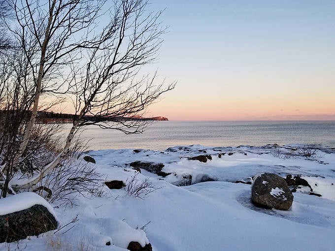 Winter transforms Iona's Beach into a snow-dusted wonderland where the pink stones peek through like buried treasure.