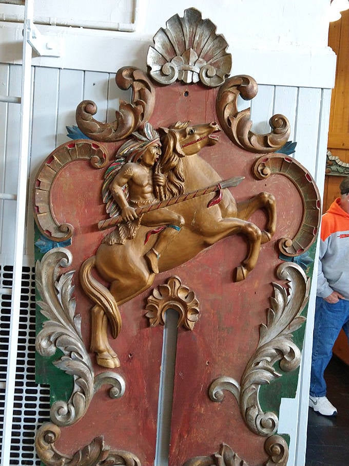 This intricately carved shield featuring a Native American warrior on a unicorn showcases the romantic mythology that often adorned carousel decorative elements.