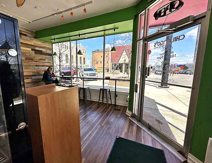 Sun-drenched window seats offer prime people-watching with your meal, connecting diners to downtown Jackson's vibrant street life.