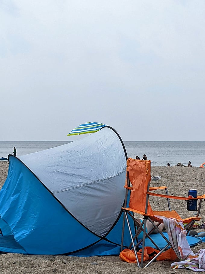 Beach tents and chairs form a temporary neighborhood of sun-seekers, united in their quest for the perfect balance of shade and breeze.