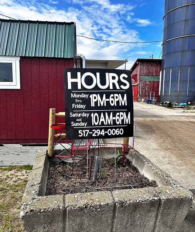 Farm hours posted on a rustic sign &ndash; these are the golden times when sunshine and flowers await your arrival.
