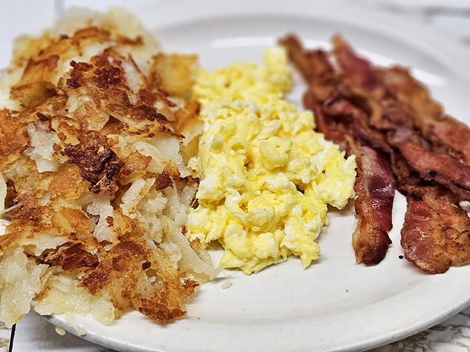 The breakfast holy trinity &ndash; crispy hash browns, fluffy eggs, and bacon cooked to that perfect balance between crisp and chewy.