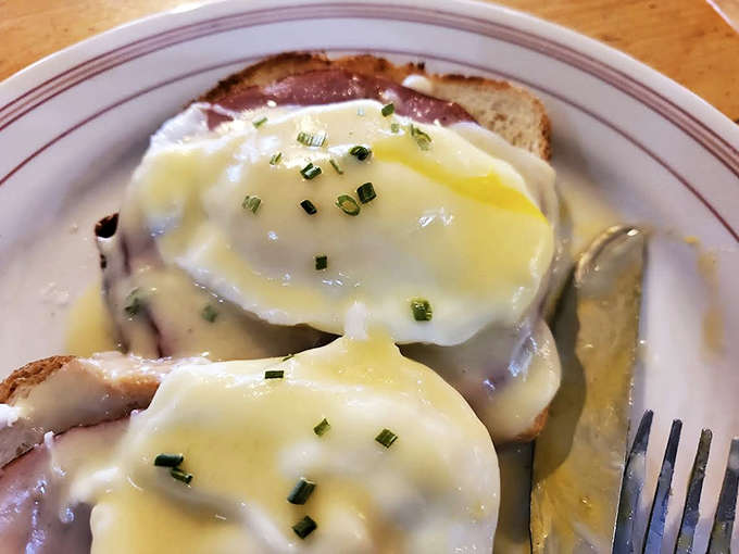 Eggs Benedict done right &ndash; perfectly poached eggs with yolks ready to cascade over Canadian bacon and English muffins.