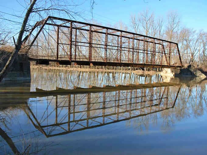 This weathered iron bridge has witnessed more Ohio history than any history book could contain, reflected perfectly in still waters below.