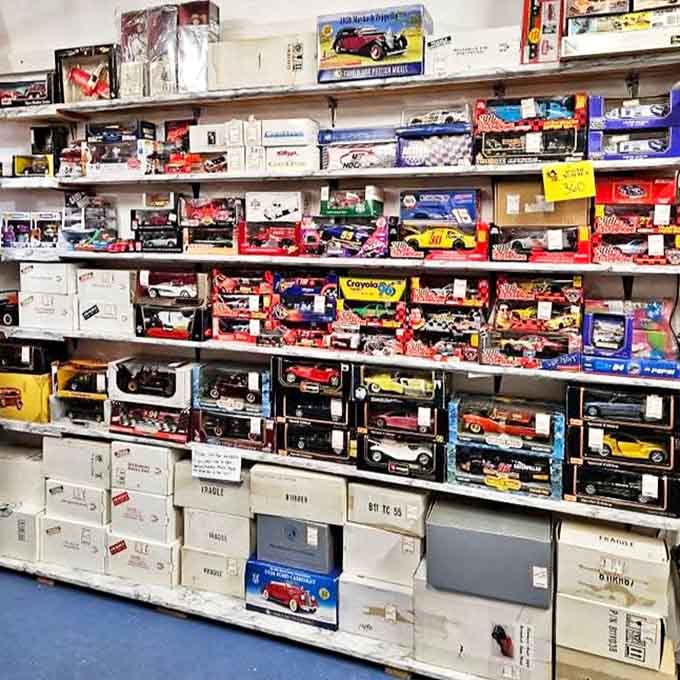Model cars and collectibles line the shelves in pristine formation, a miniature automotive museum celebrating America's love affair with the automobile.