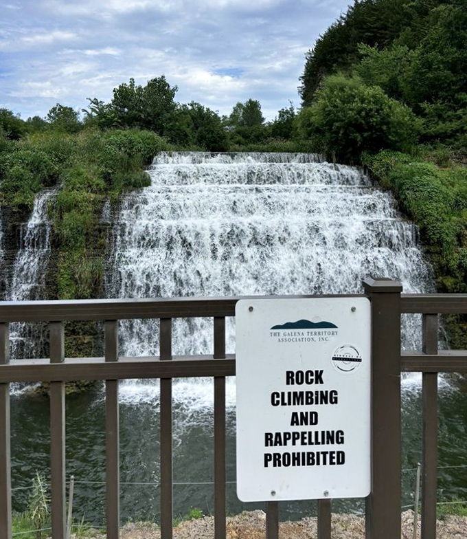The "no climbing" sign exists because someone, somewhere, thought scaling a waterfall was a brilliant idea.