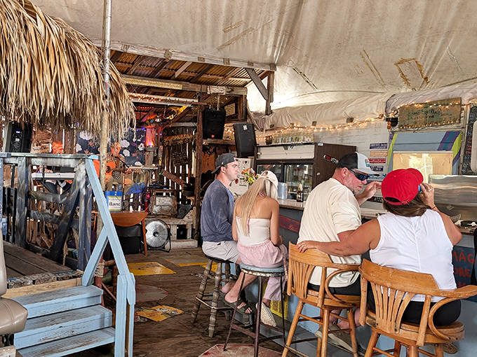 Island regulars and curious tourists share stories and spirits at this beloved institution where "dress code" means "wearing something."