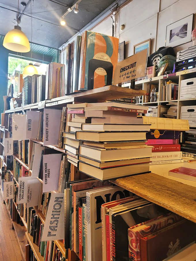 The checkout station, piled high with recent acquisitions, serves as both transaction point and informal recommendation center.