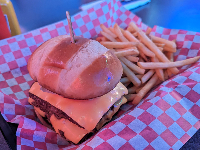 The cheeseburger arrives speared with a toothpick &ndash; the culinary equivalent of planting a flag on a delicious mountain you're about to conquer.