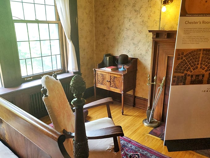 This modest bedroom preserves early 20th-century simplicity, where even the hat and walking stick seem to await their owner's imminent return.