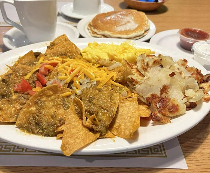 Chilaquiles bring morning sunshine with tortilla chips swimming in sauce, topped with cheese that stretches with each forkful.