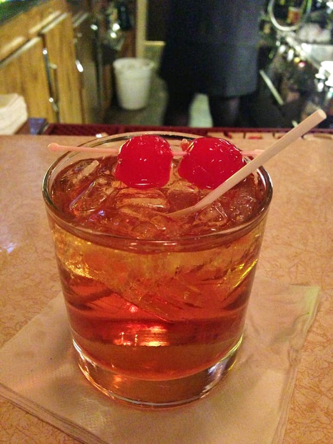 An Old Fashioned cocktail garnished with bright red cherries, the unofficial state drink of Wisconsin and the perfect start to any supper club experience.
