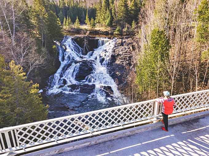 Eagle River Falls: Nature's own symphony in motion, where rushing waters cascade over ancient rocks while visitors snap photos from the safety of the bridge.
