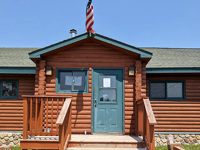 The log cabin entrance sets the tone for what awaits inside: authentic north woods charm without a hint of pretension.