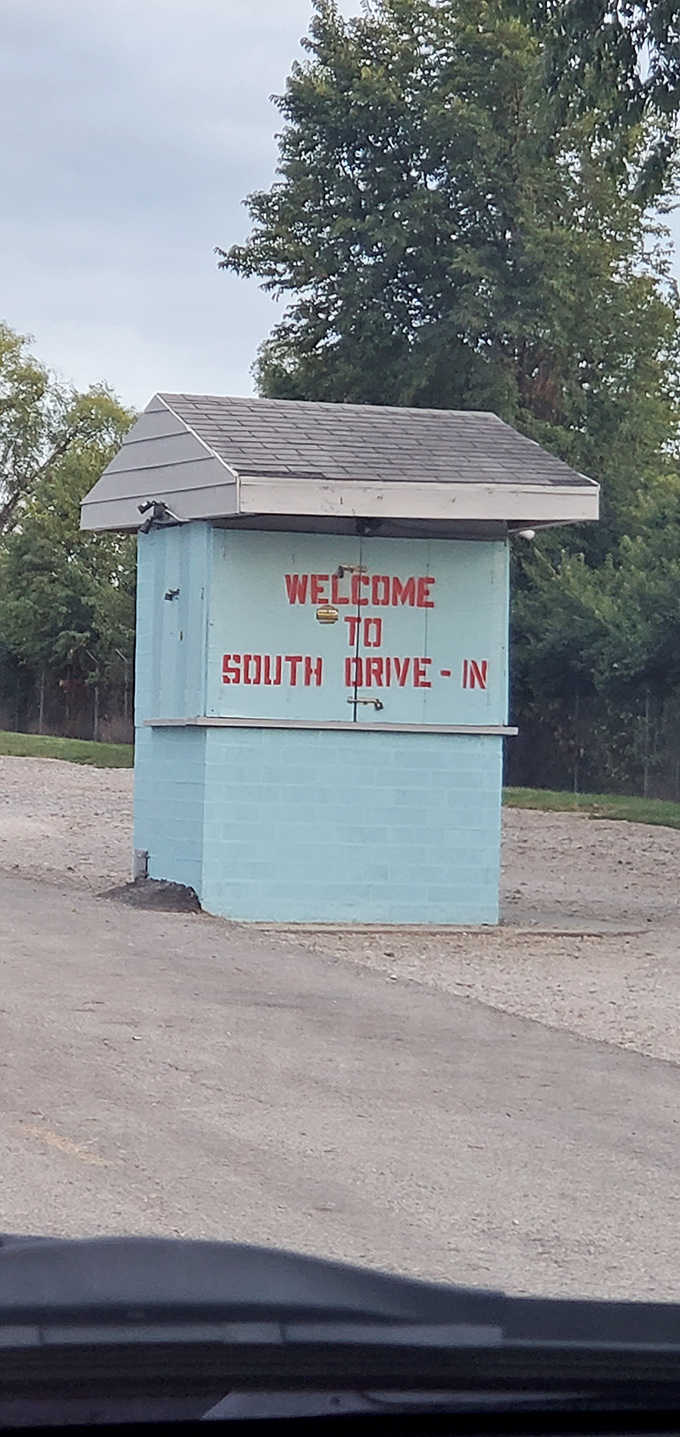 The iconic blue entrance booth welcomes visitors with retro charm, standing as a cheerful gatekeeper to evenings of outdoor entertainment.