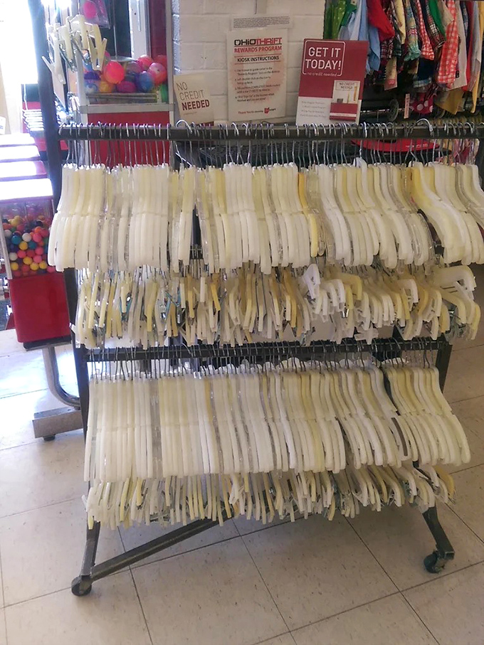 Hangers full of possibilities in white and organized rows, because even chaos needs a little structure to function properly.