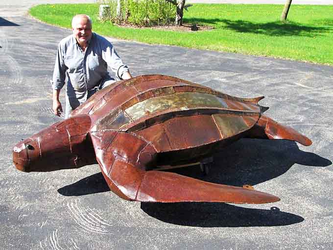 This magnificent sea turtle seems to glide across the pavement, its shell a testament to the artist's skill with repurposed materials.