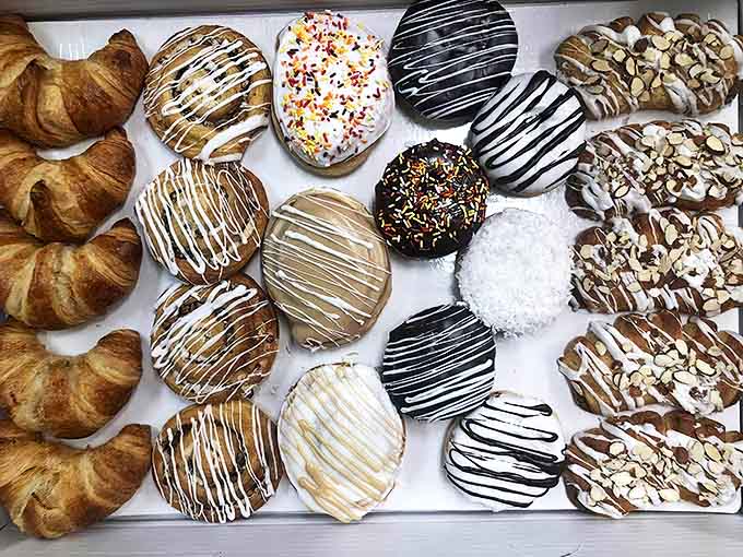 The bakery case presents an impossible choice – each pastry more tempting than the last, all made with small-batch care.