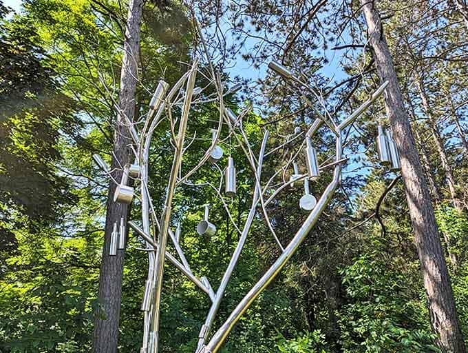 Silver branches adorned with metallic "fruit" create a musical garden when breezes blow, turning nature's whispers into delicate chimes.